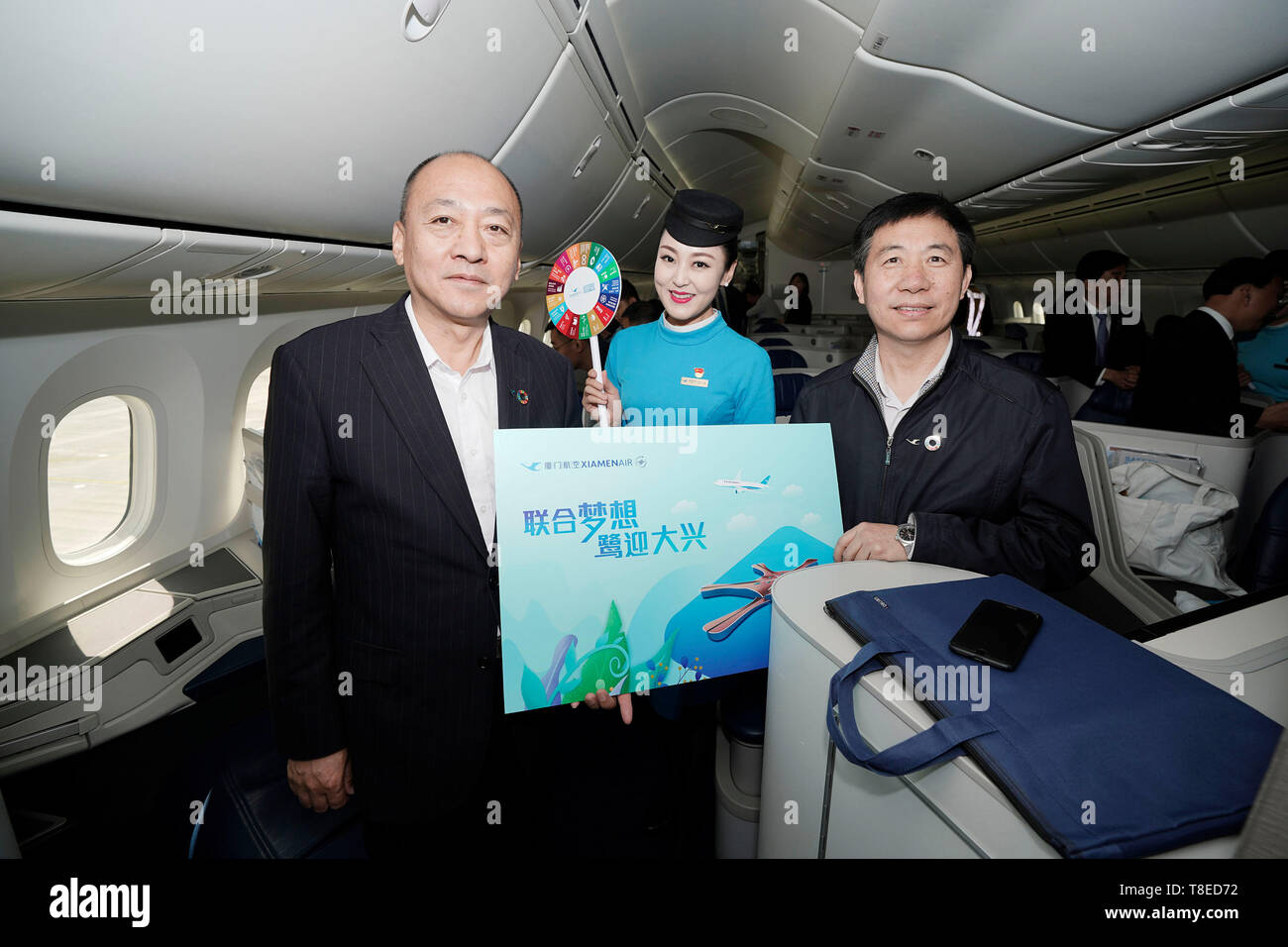 Beijing, China. 13th May, 2019. Crew members of Xiamen Airlines pose ...