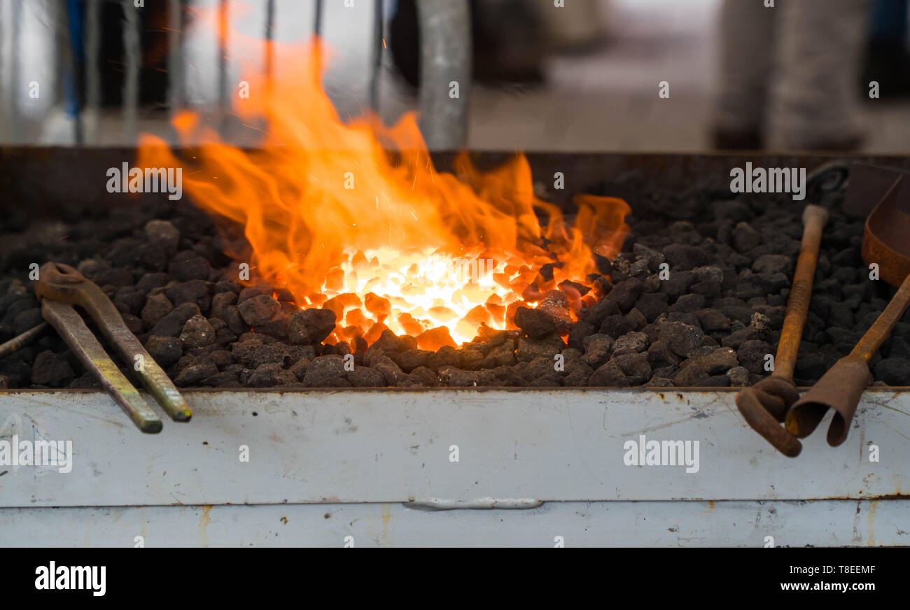 Farrier's furnace with flaming coals and forging tools Stock Photo - Alamy