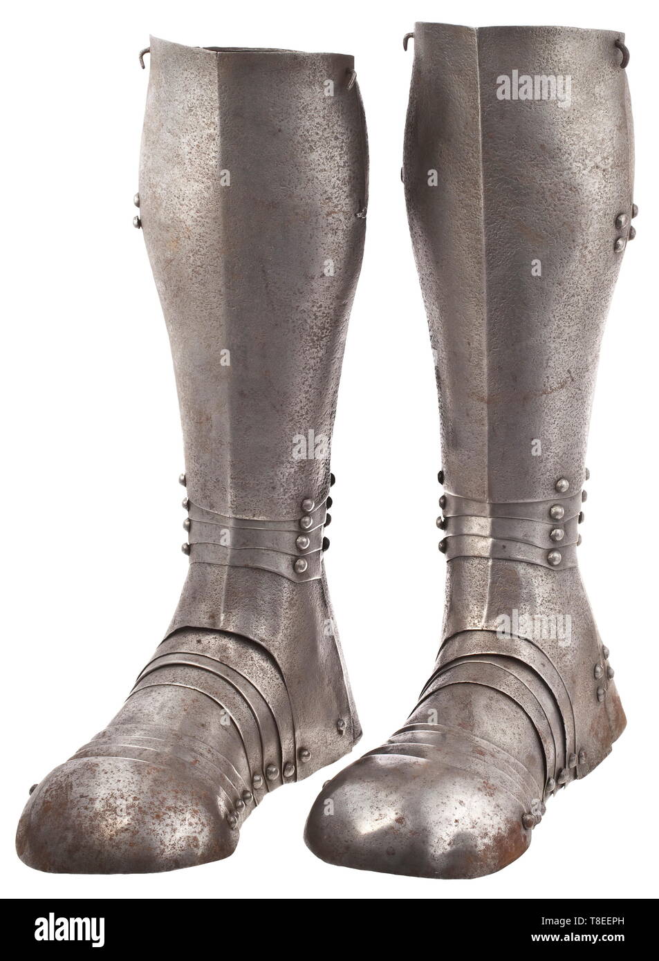 A pair of greaves and sabatons in the style of the second half of the ...