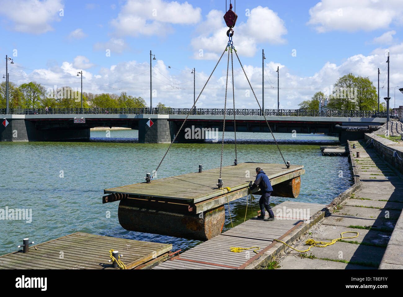 Placing a floating marina pontoon in the water with the help of a crane ...