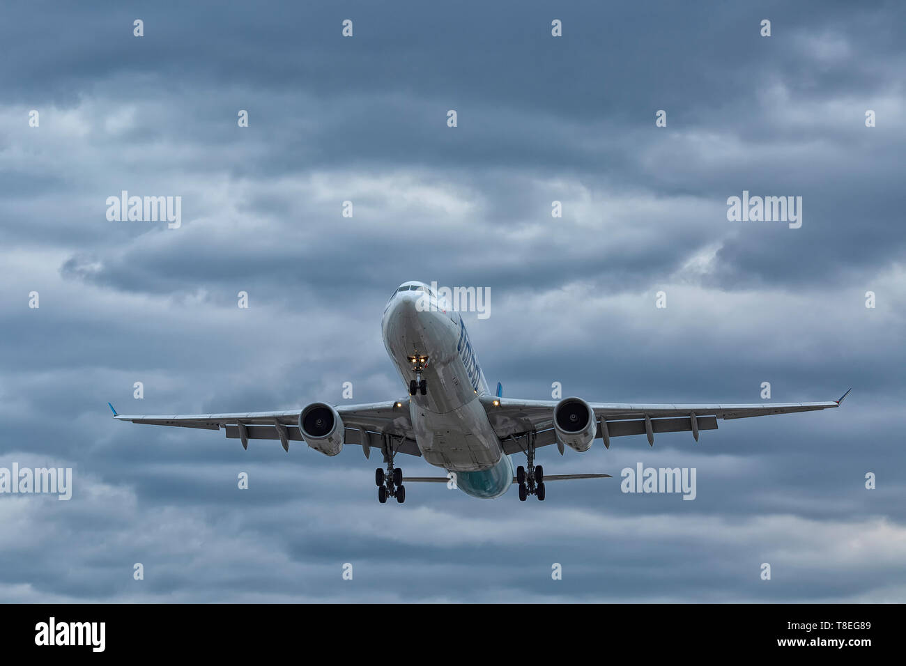 Passenger jet plane landing with wheels down. Toronto Ontario Canada ...