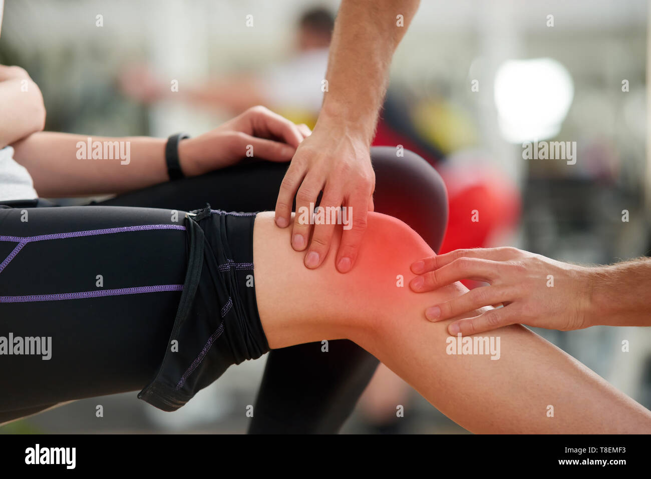 Muscle cramp during workout. Male hands helping relieve pain in female ...