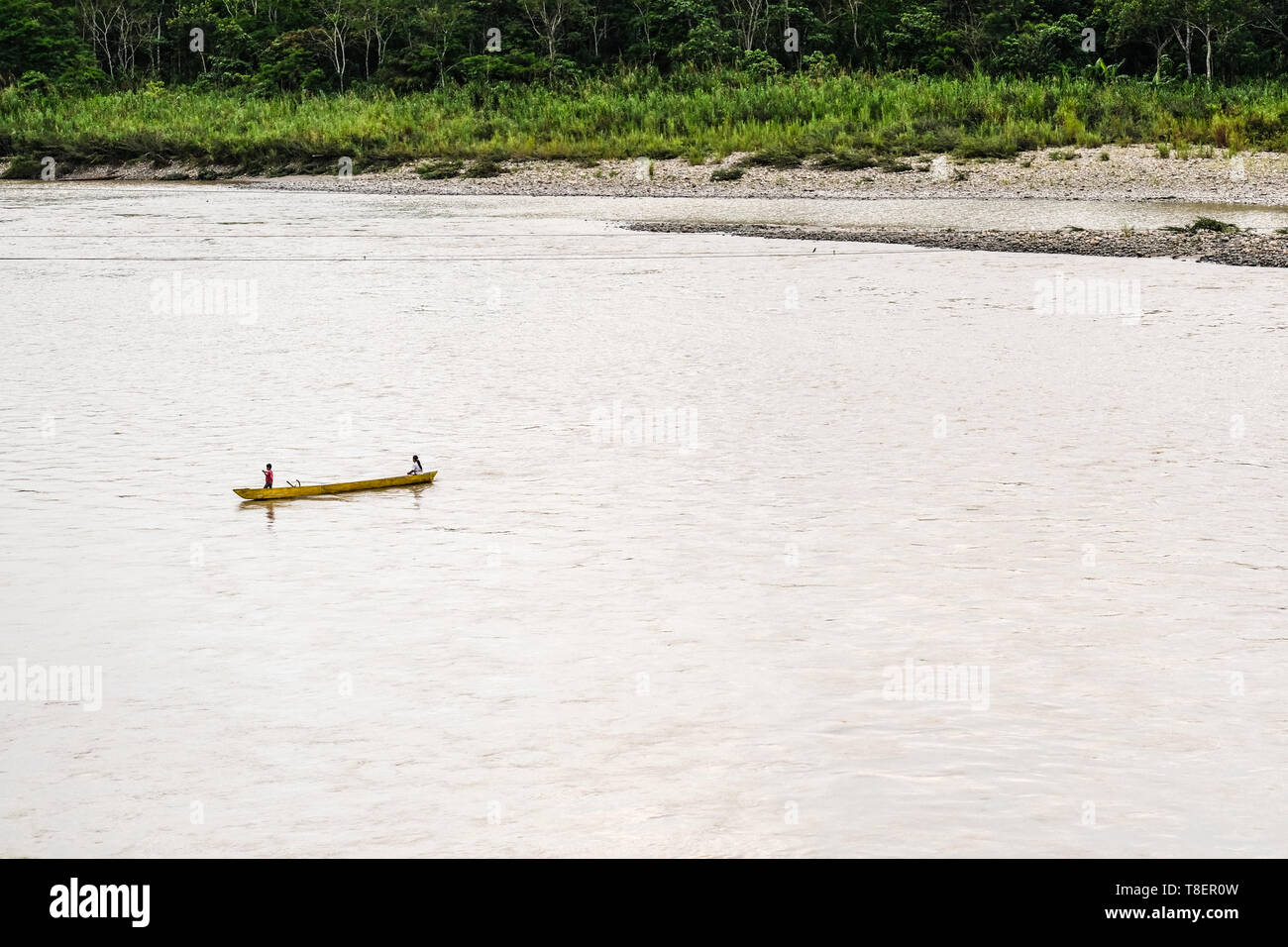Two indigenous people paddling canoe in Rio Napo river in Ecuador Stock ...