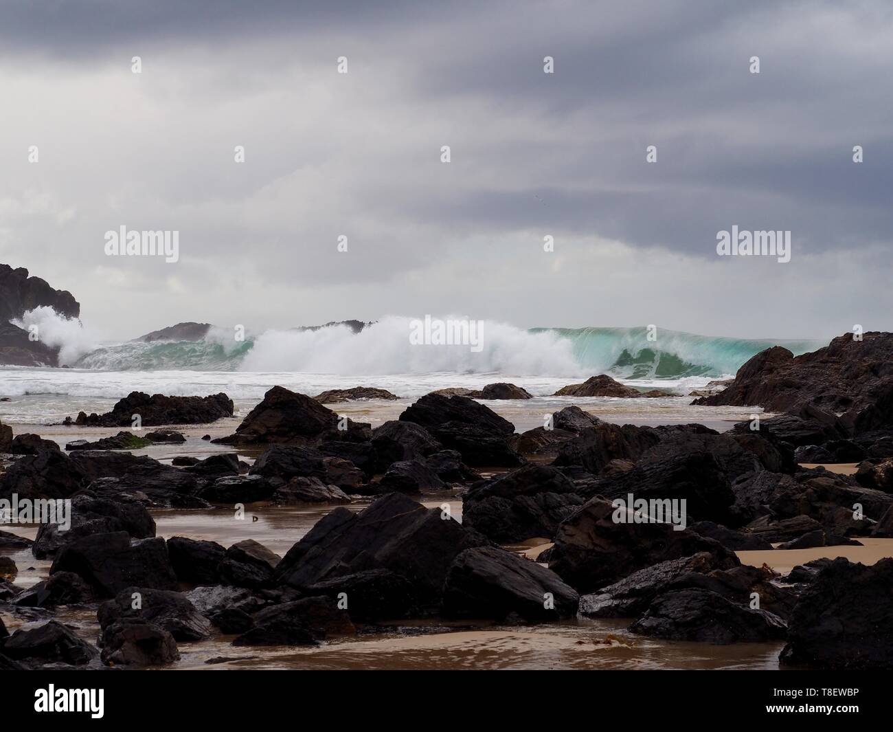 Waves rolling in at the beach Stock Photo - Alamy