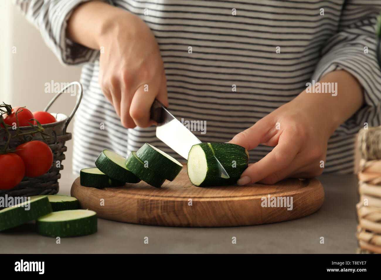 Woman cutting courgette hi-res stock photography and images - Alamy