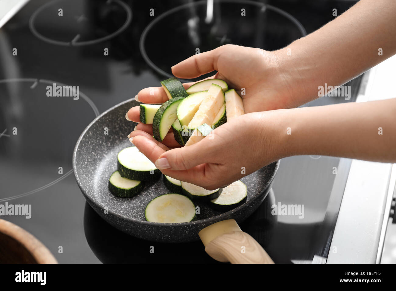 Person cooking sliced zucchini in hi-res stock photography and images ...