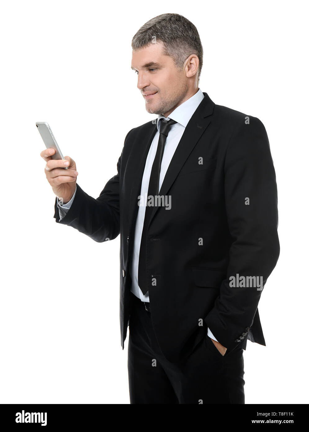 Handsome confident businessman with mobile phone on white background Stock Photo - Alamy