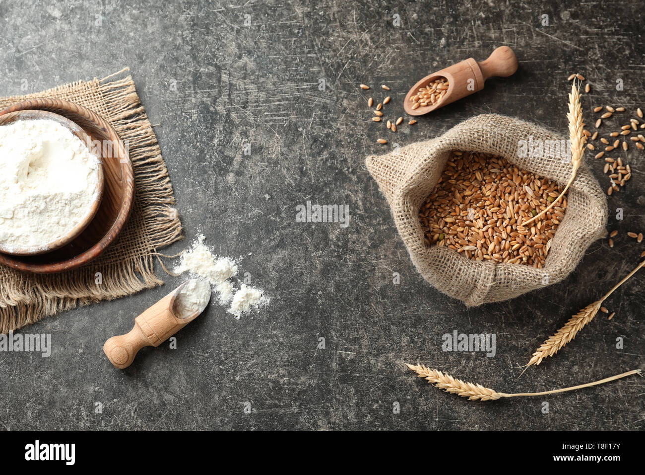 Composition with wheat and flour on grey background Stock Photo - Alamy