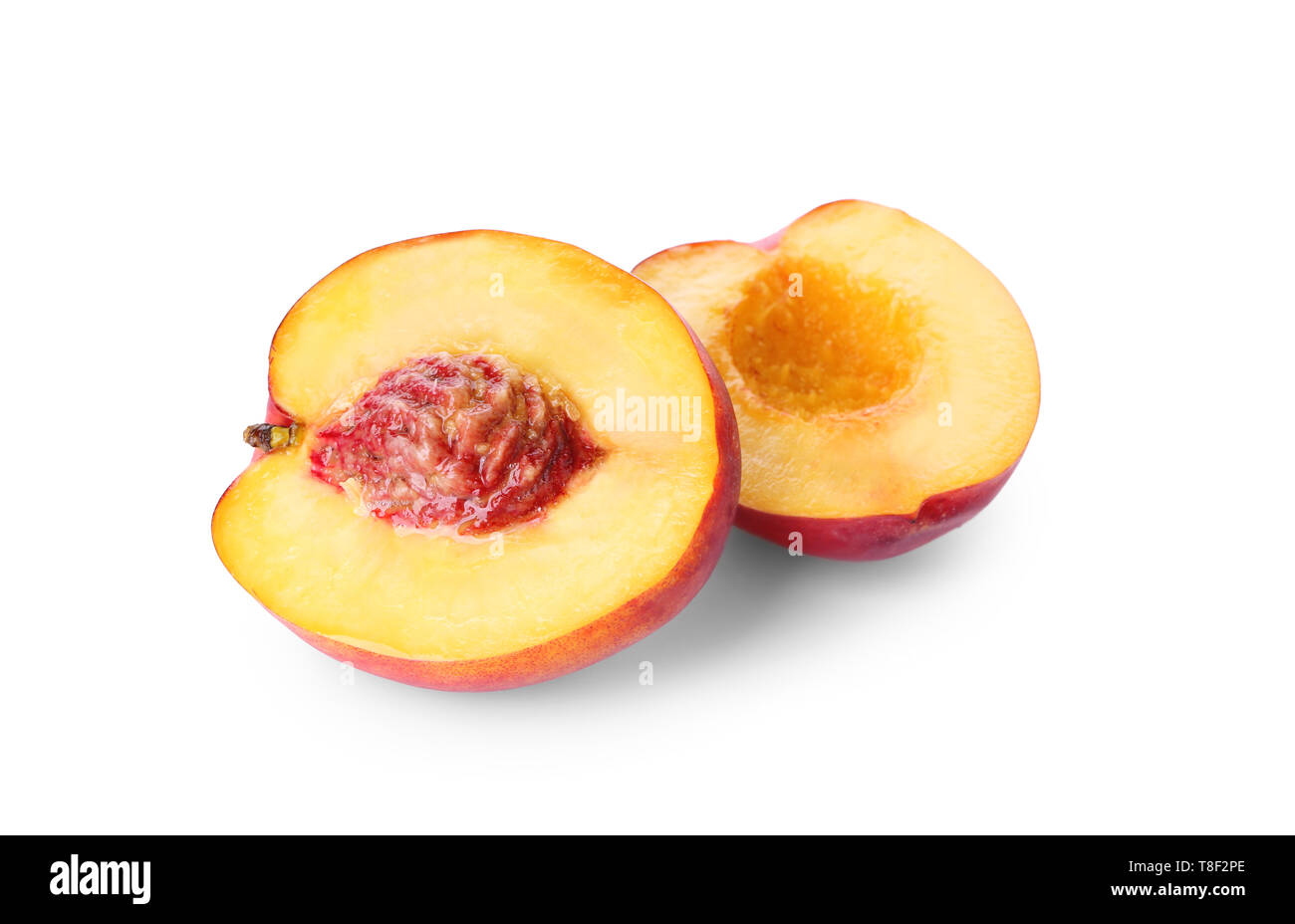 Halves of fresh peach on white background Stock Photo - Alamy