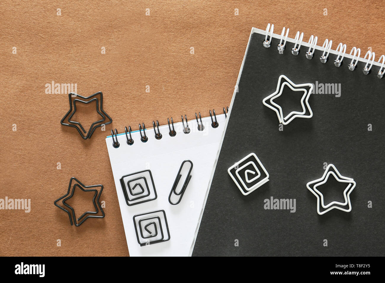 Set of notebooks with clips on color background Stock Photo - Alamy
