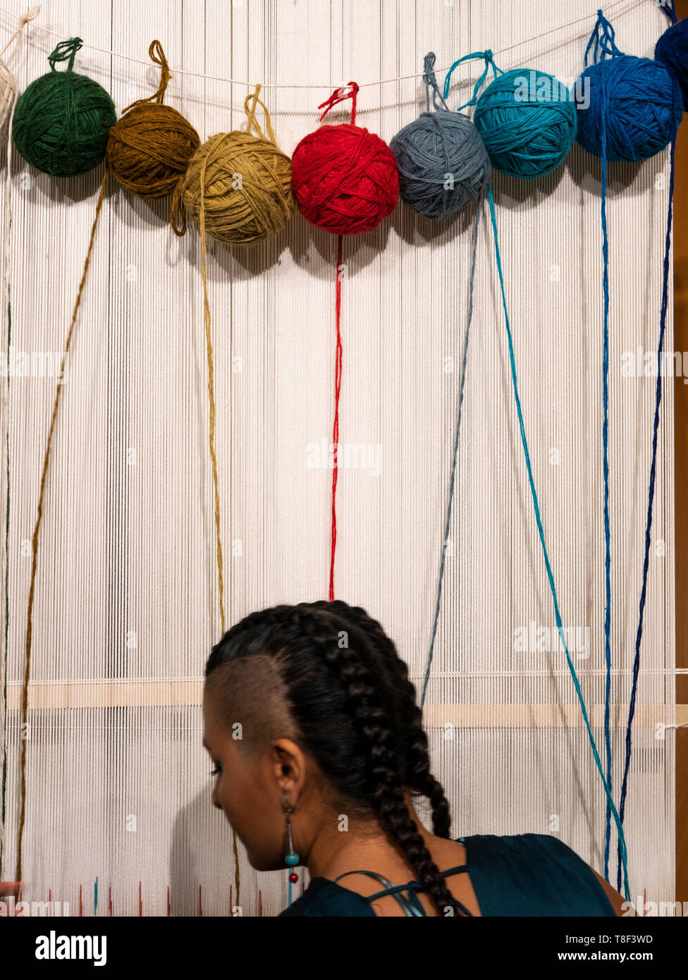Traditional rug weaving. Contemporary looking woman doing flat weave ...