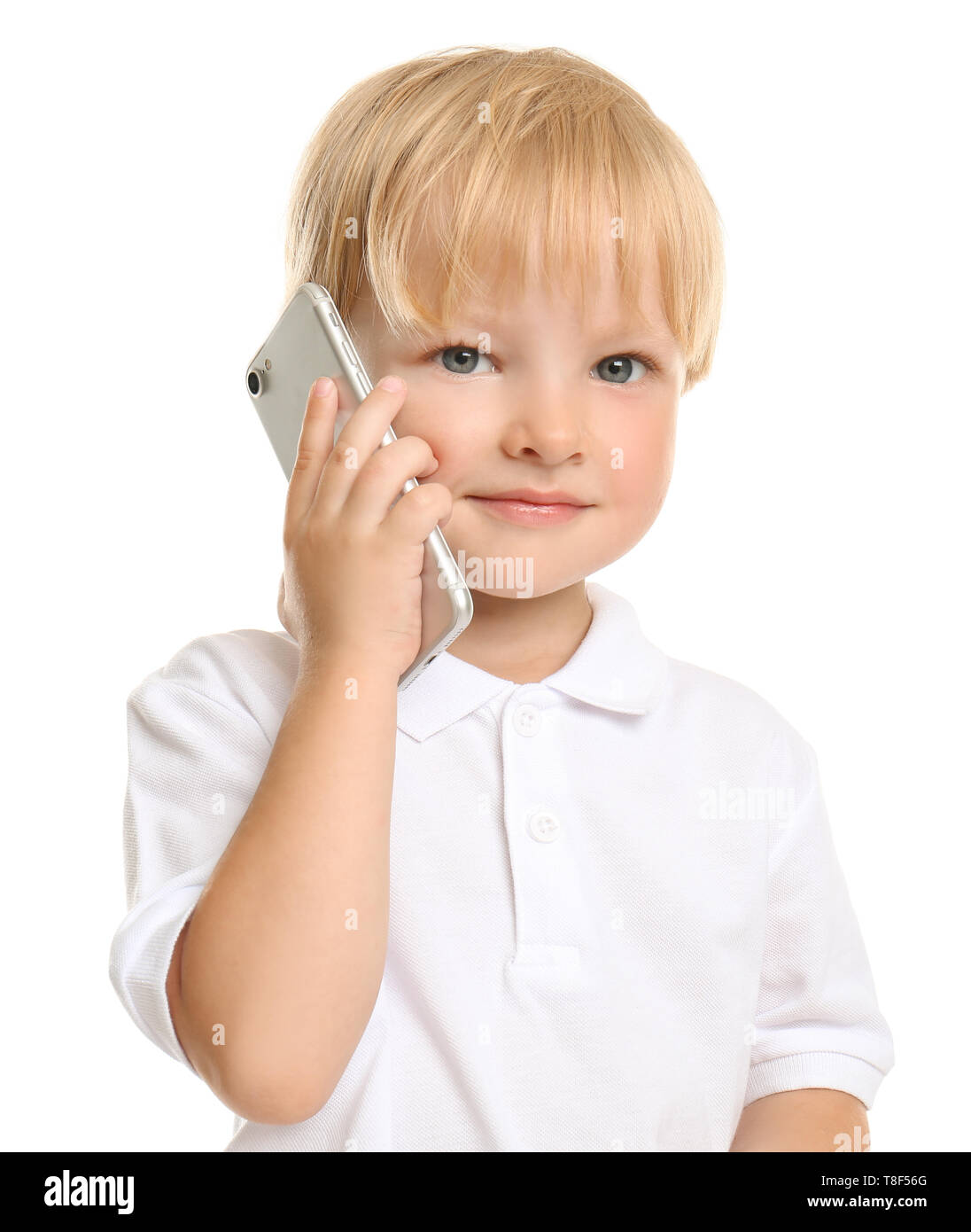 Cute little boy talking on mobile phone against white background Stock ...