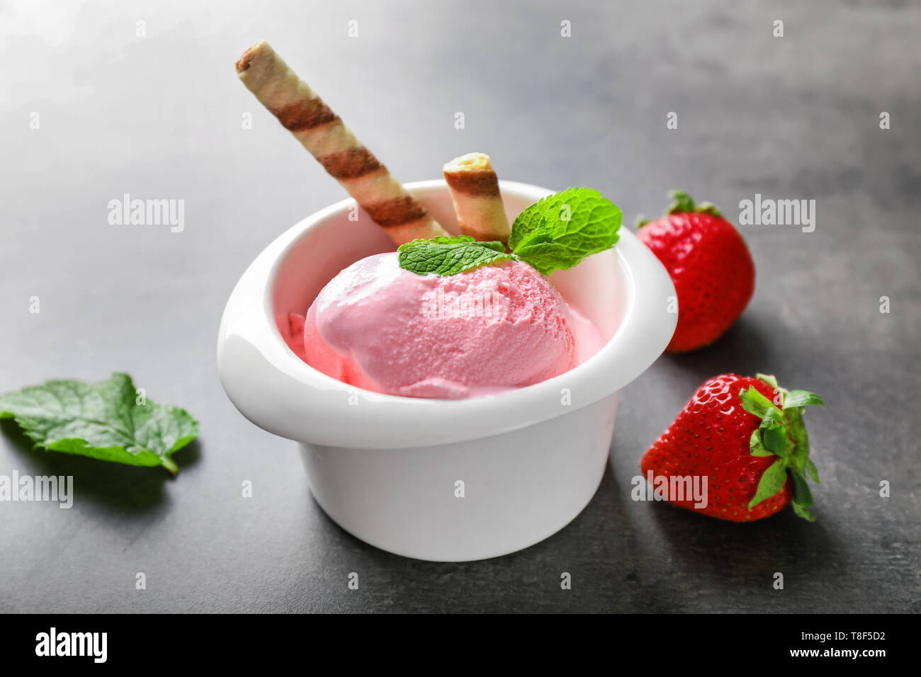 Bowl with delicious strawberry ice-cream on grey table Stock Photo - Alamy