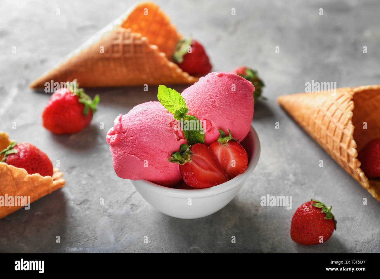 Bowl with delicious strawberry ice-cream on grey table Stock Photo - Alamy