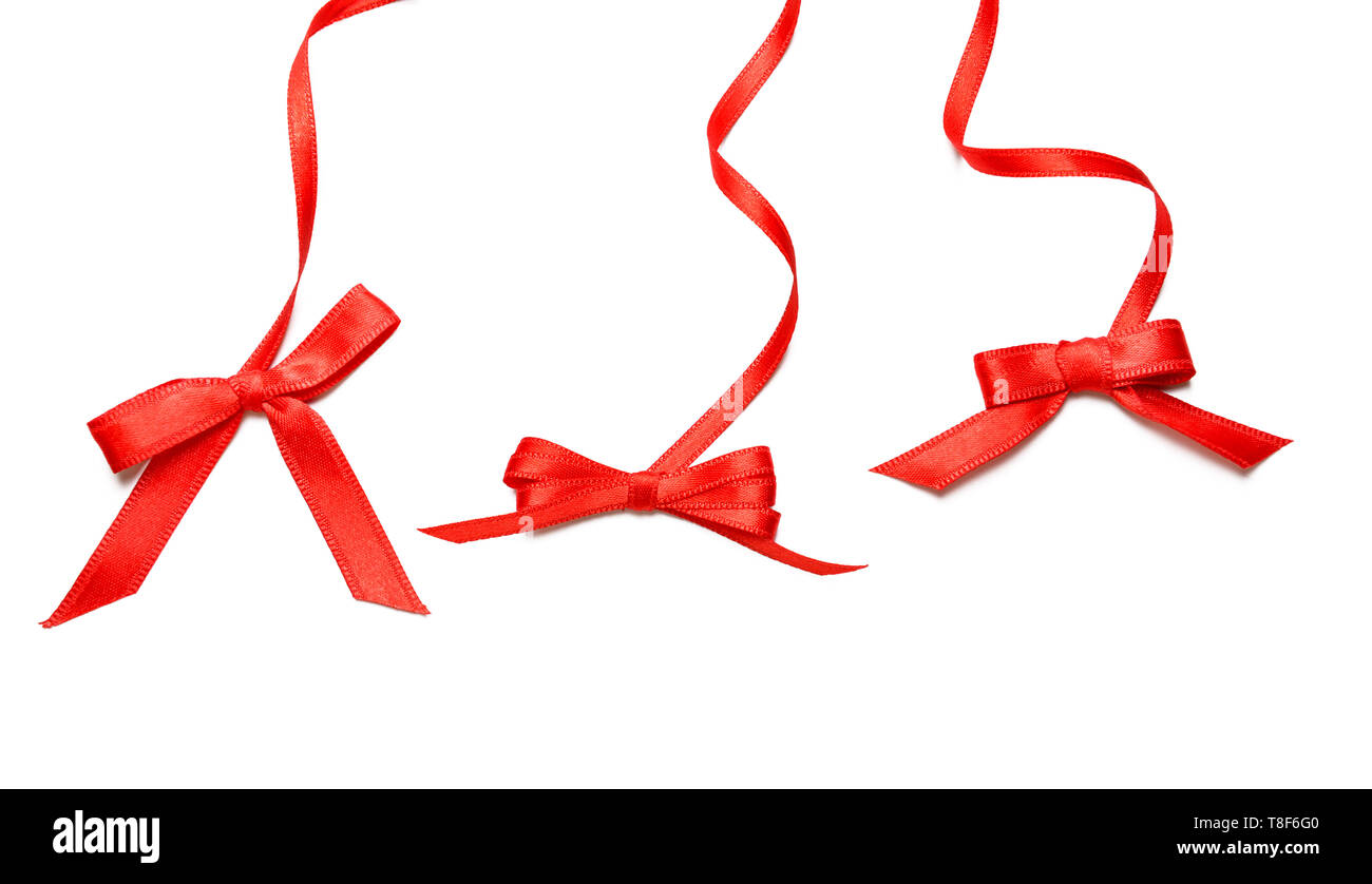 Red ribbons with beautiful bows on white background Stock Photo - Alamy