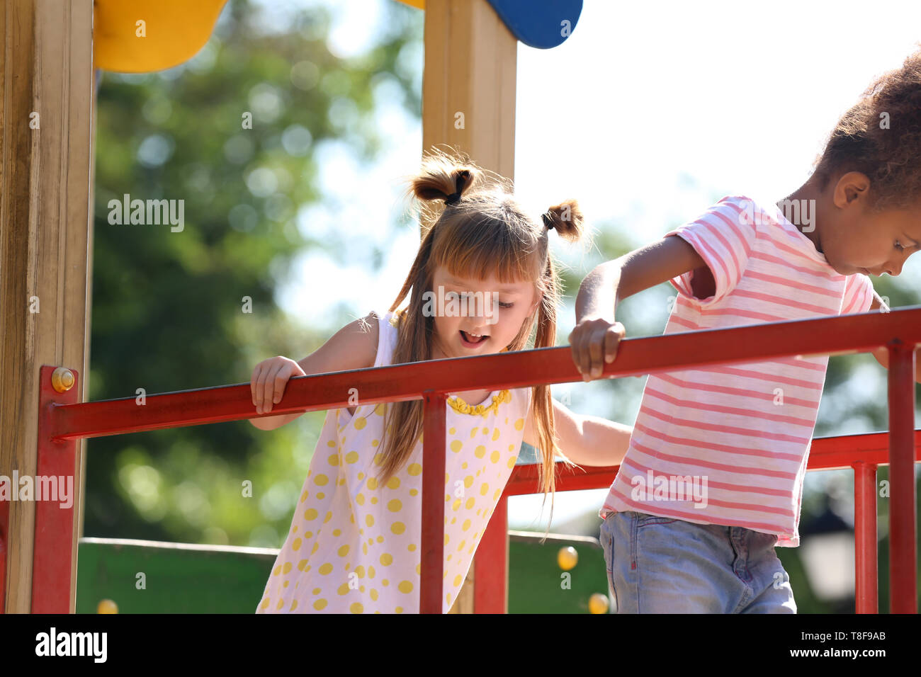 Cute little children having fun on playground outdoors Stock Photo - Alamy