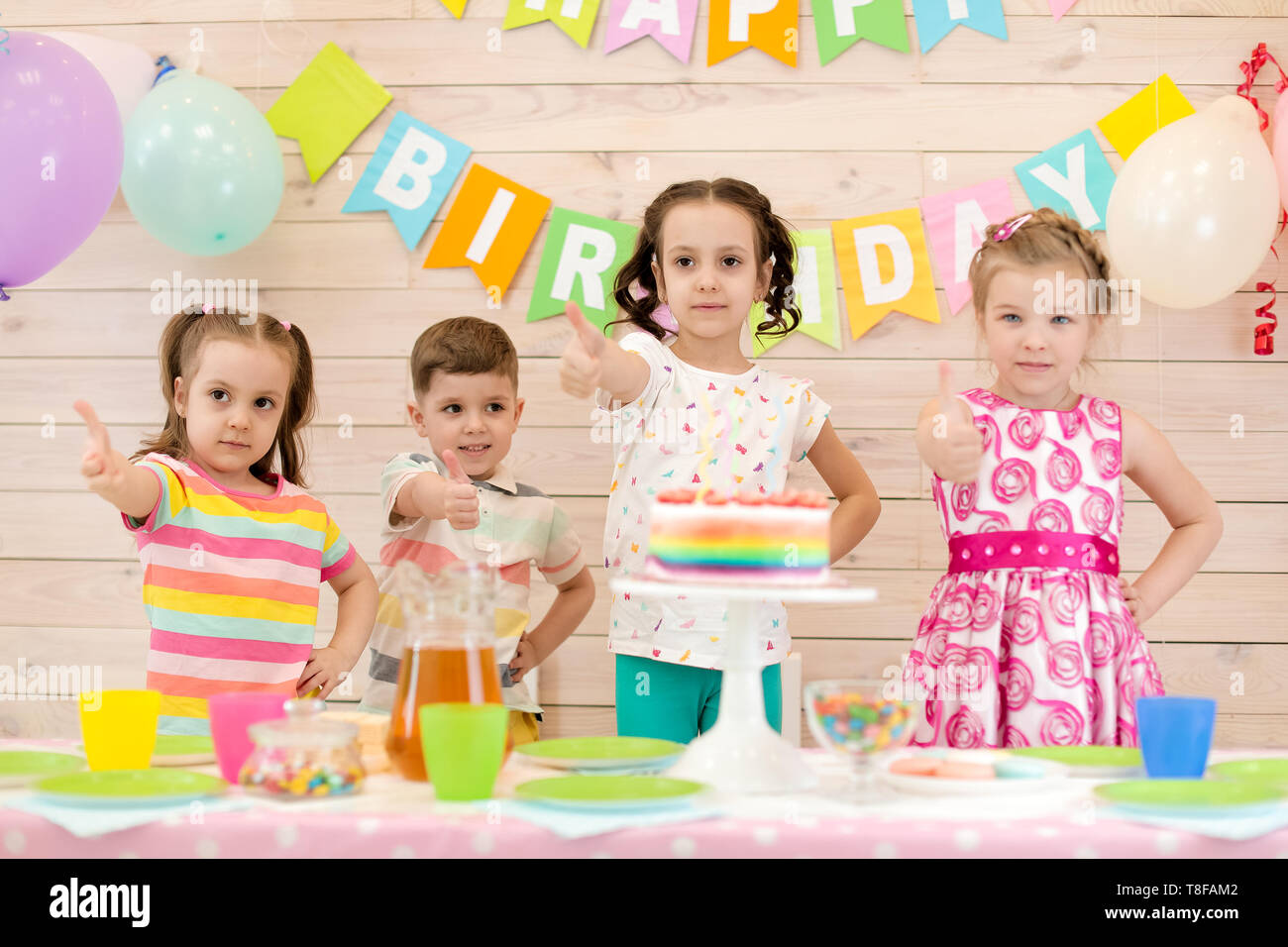 Children celebrating birthday party. Happy kids showing thumbs up Stock ...