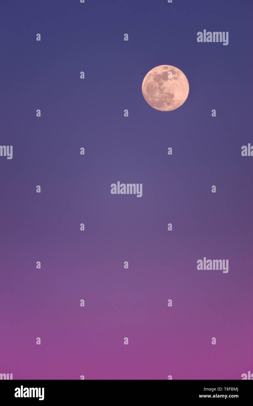 An oversaturated sky with a full super moon Stock Photo - Alamy