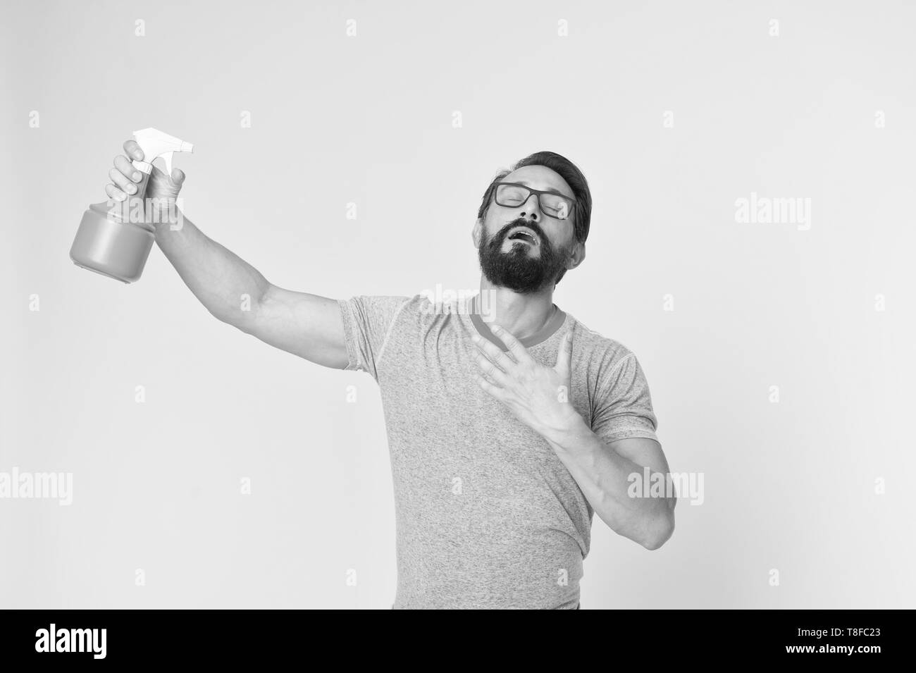 Refresh concept. Bearded man with eyeglasses refresh sprinkling water ...