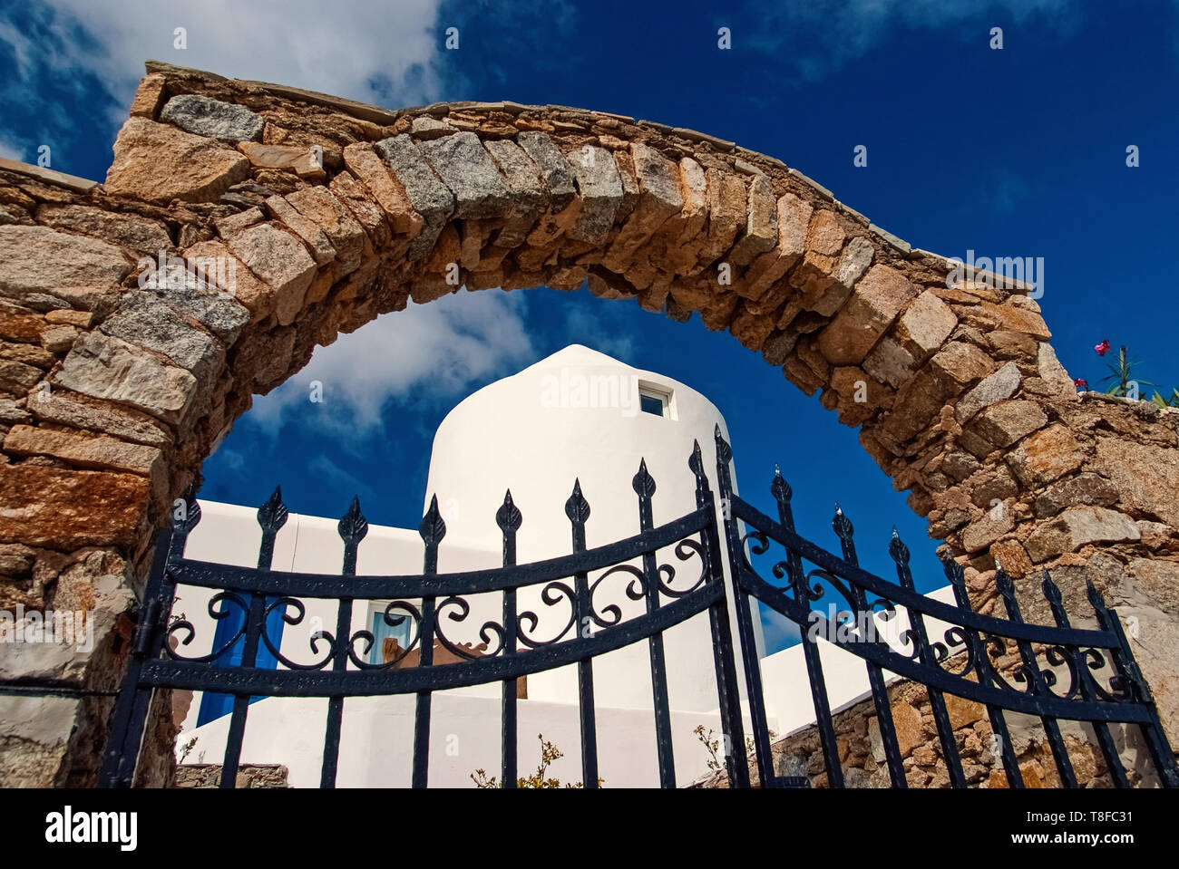 Iron gate and stone arch in Mykonos, Greece. Archway structure or ...