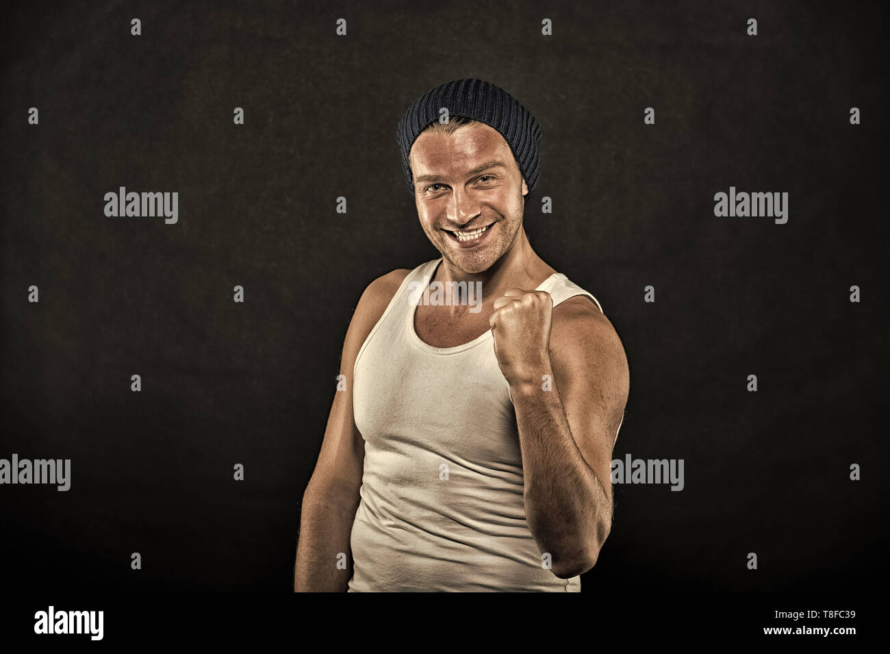 Macho on smiling face with strong muscles look brutal, black background ...