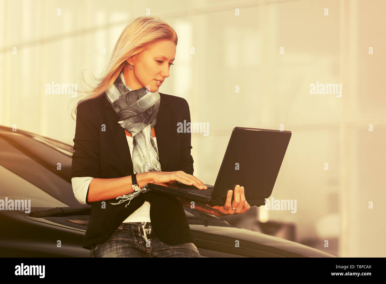 Young fashion business woman with laptop sitting on her car Stylish ...