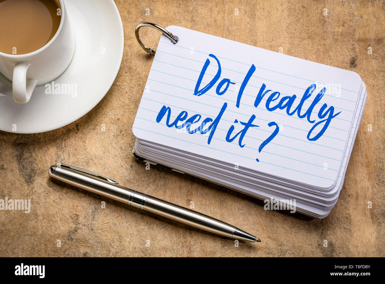 Do I really need it? Minimalism concept - handwriting on a stack of ...