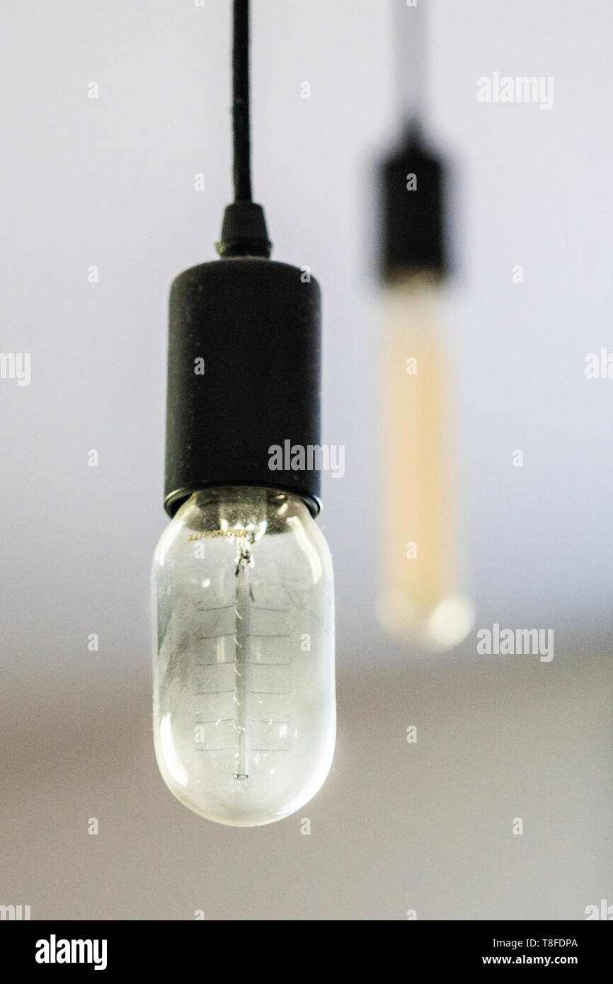 vintage light bulb hangs in a dining room Stock Photo - Alamy
