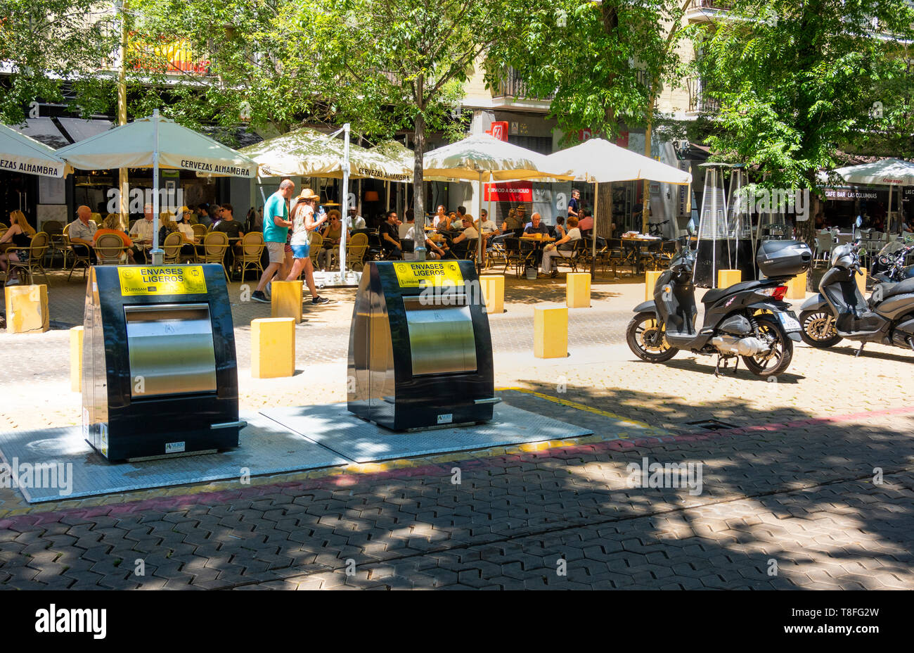 New trash disposal units in front of a cafe in the Alameda de Hercules ...