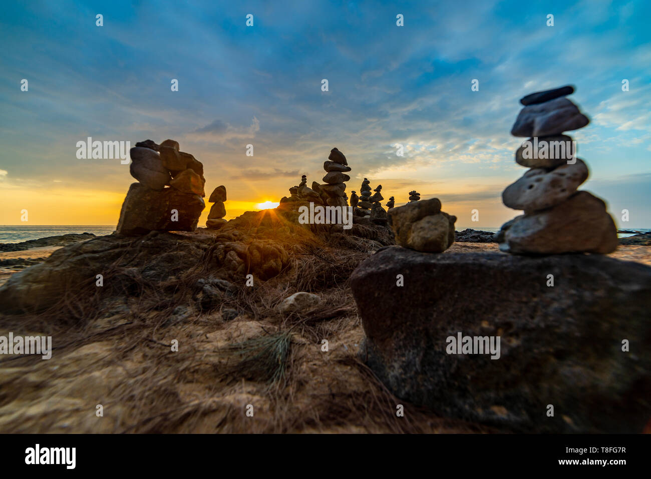 Zen stacked stones at the beach at sunset Stock Photo - Alamy