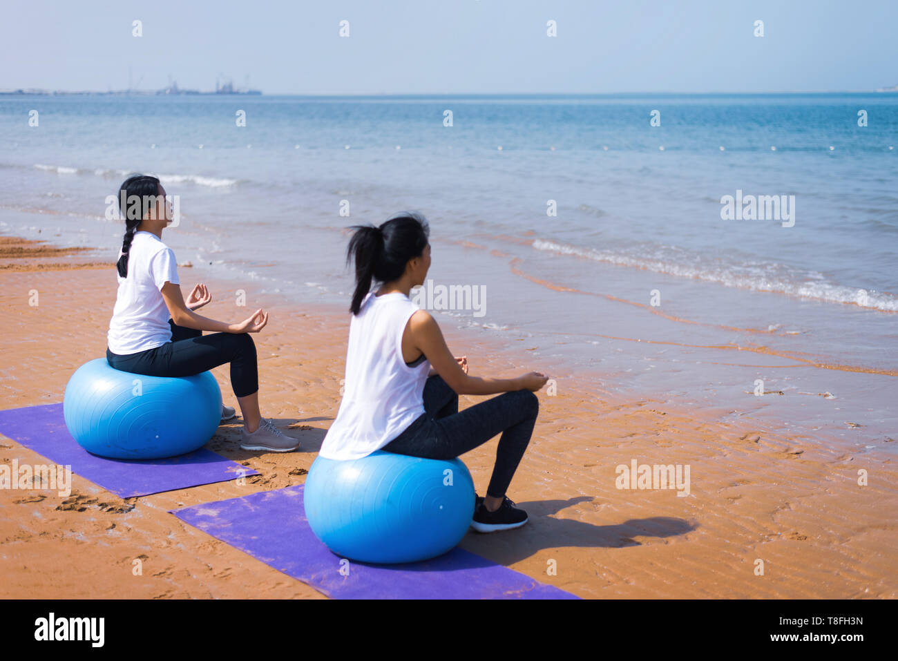 Two women sit on the beach hi-res stock photography and images - Alamy