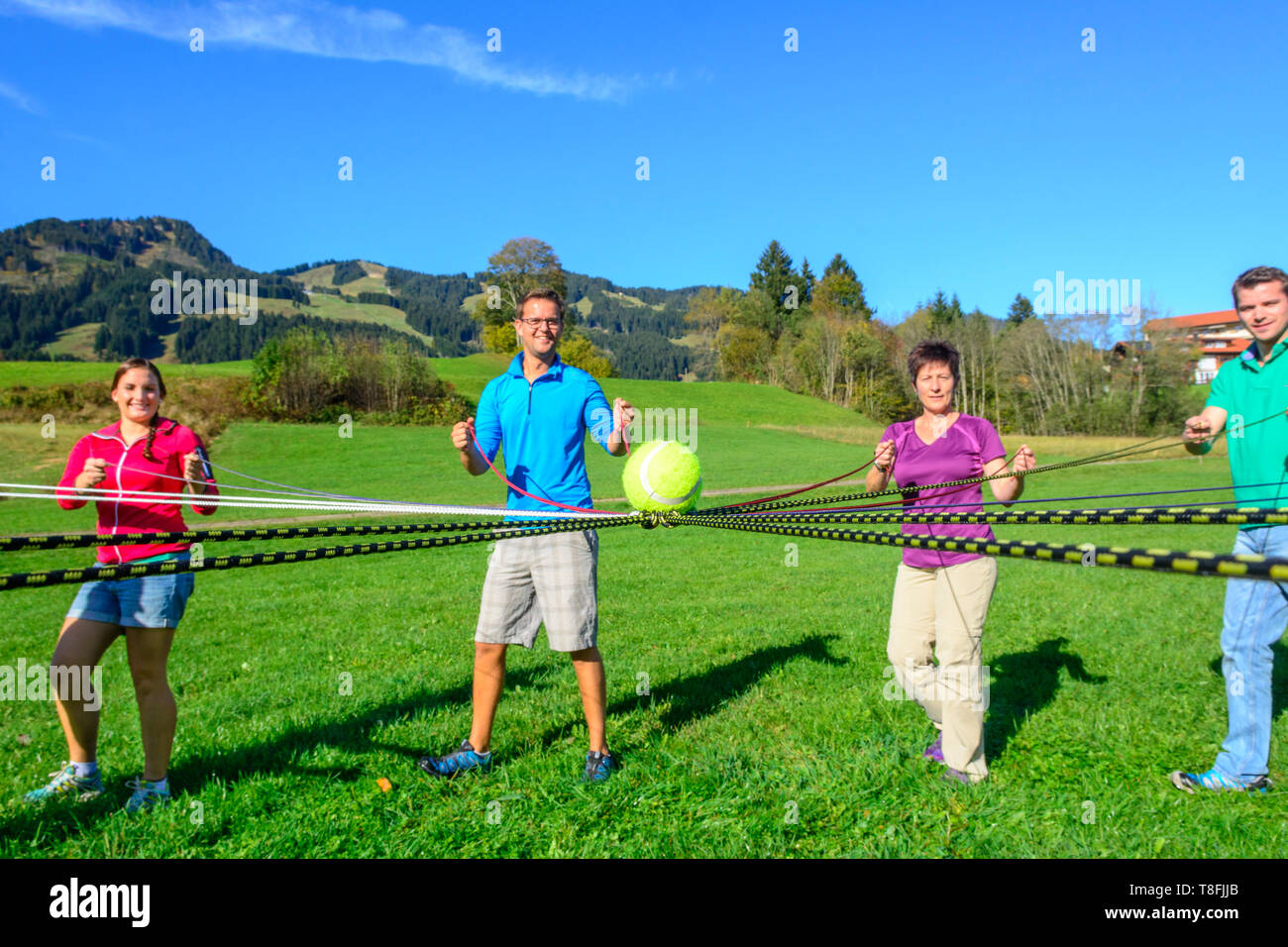 Teambuilding exercise called ball transport Stock Photo - Alamy