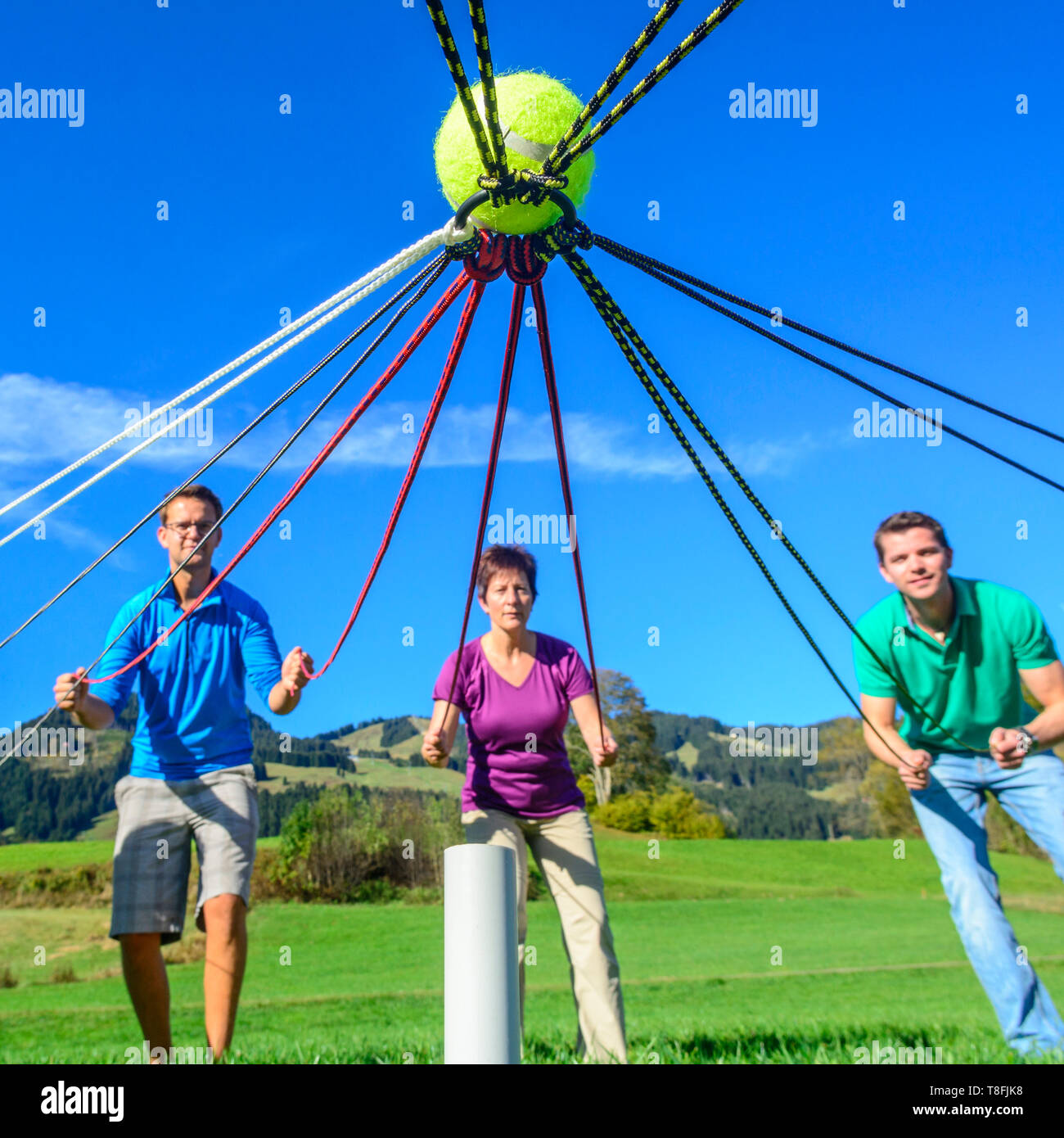 Teambuilding exercise called ball transport Stock Photo - Alamy