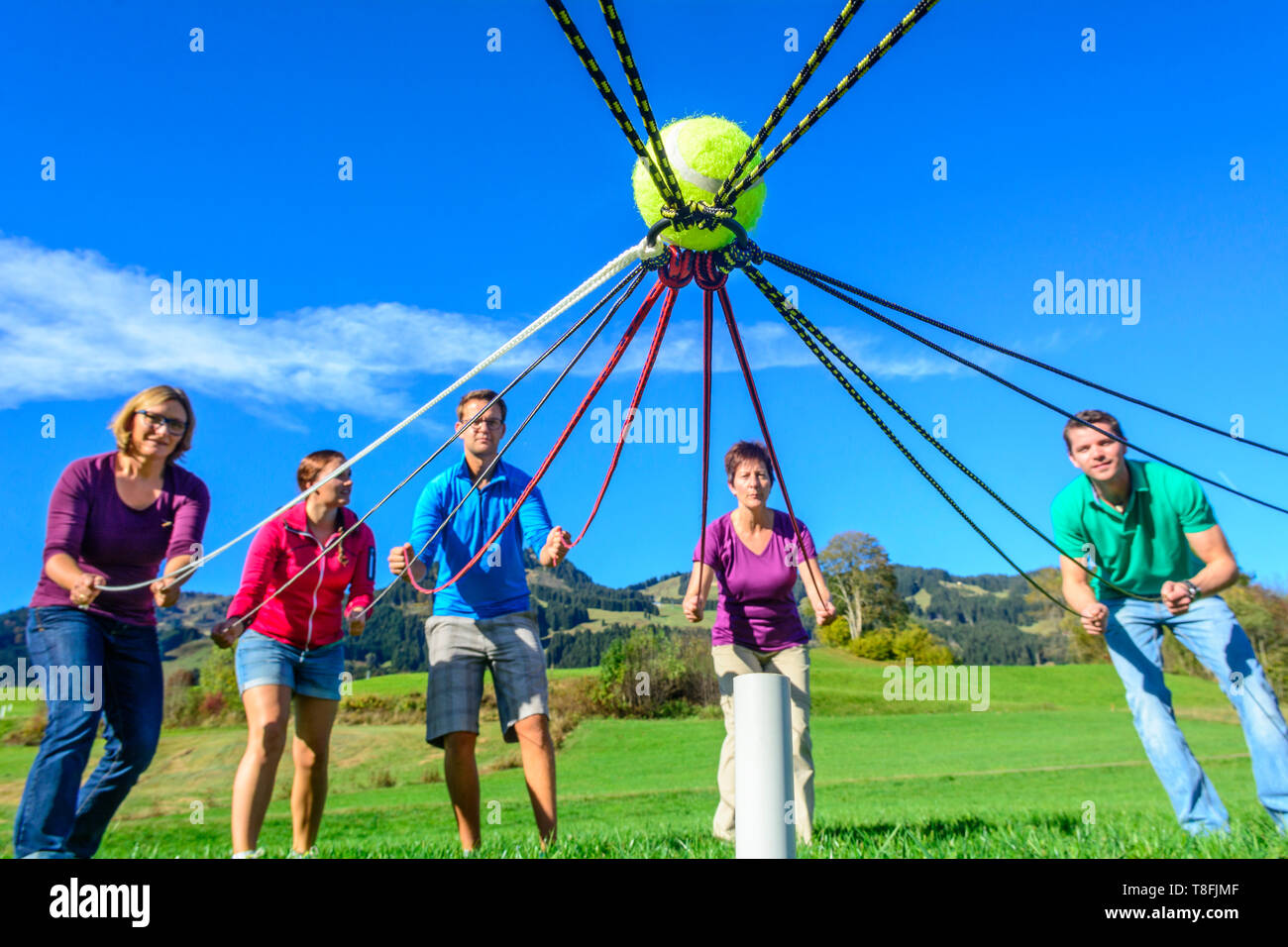 Teambuilding exercise called ball transport Stock Photo - Alamy