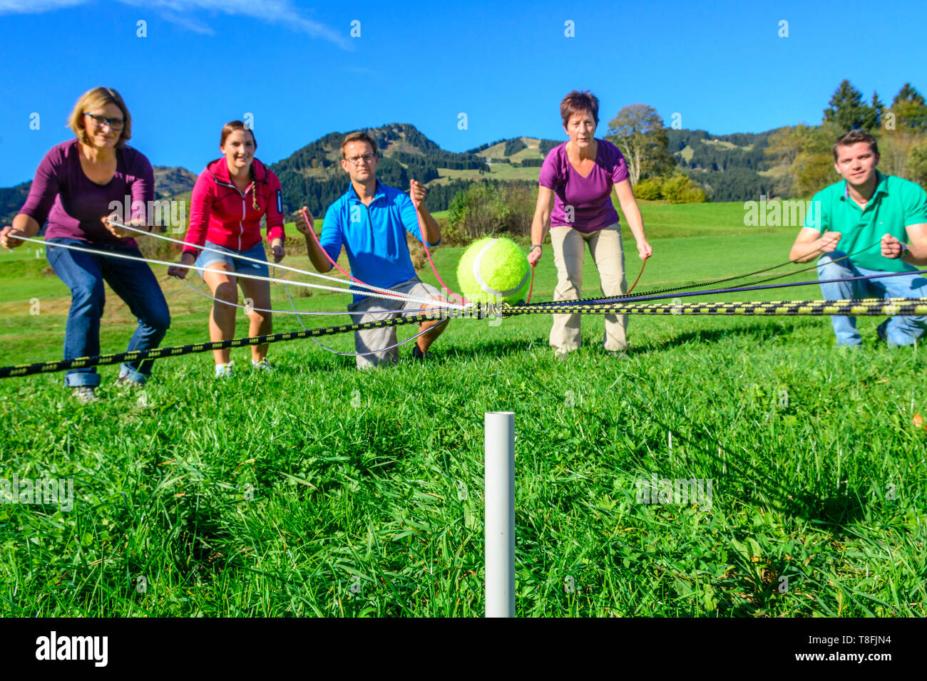 Teambuilding exercise called ball transport Stock Photo - Alamy