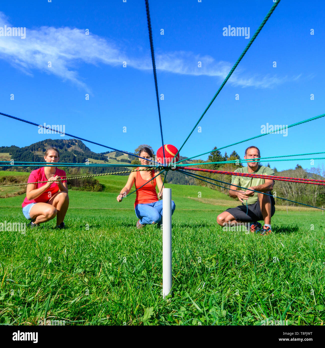 Teambuilding exercise called ball transport Stock Photo - Alamy