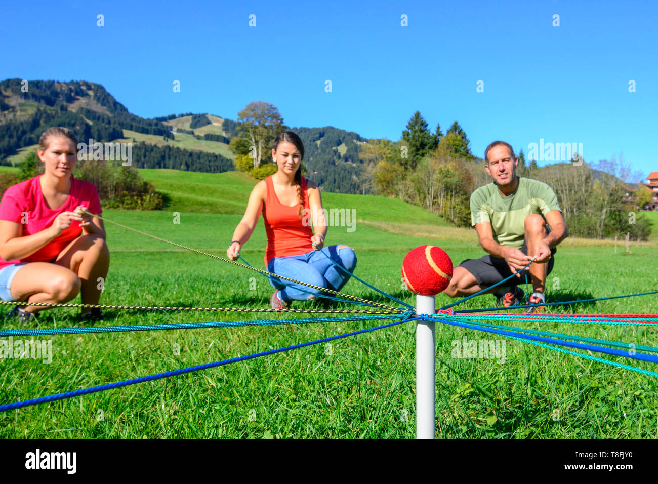 Teambuilding exercise called ball transport Stock Photo - Alamy