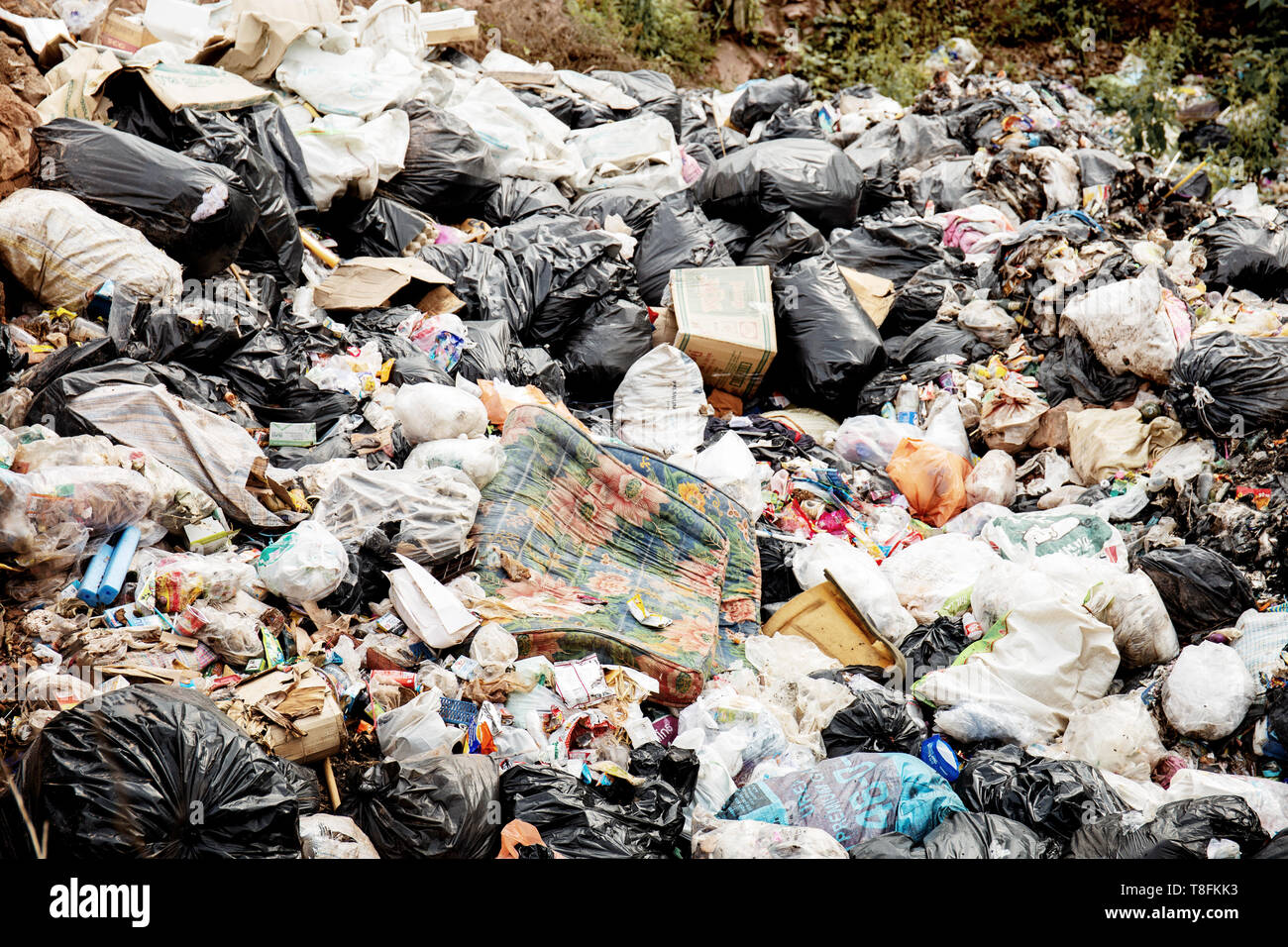 Garbage in fields with dirt and stench on ground Stock Photo - Alamy