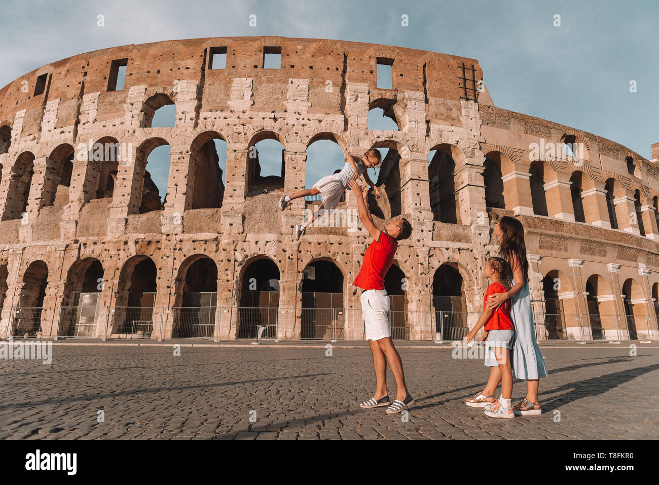 Happy family in Europe. Parents and kids in Rome over Coliseum ...