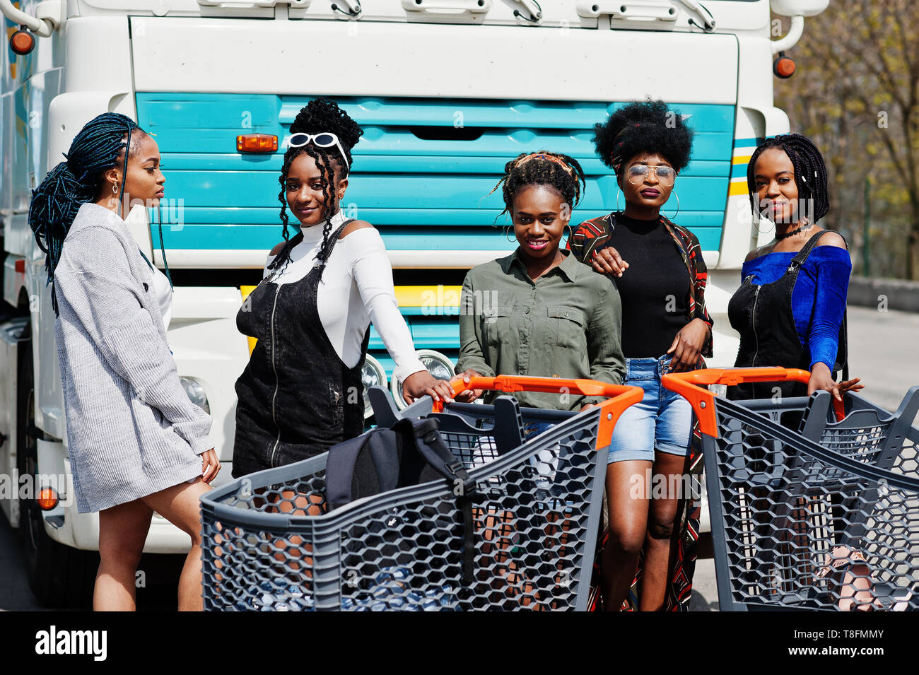 Group of five african american woman with shopping carts having fun ...