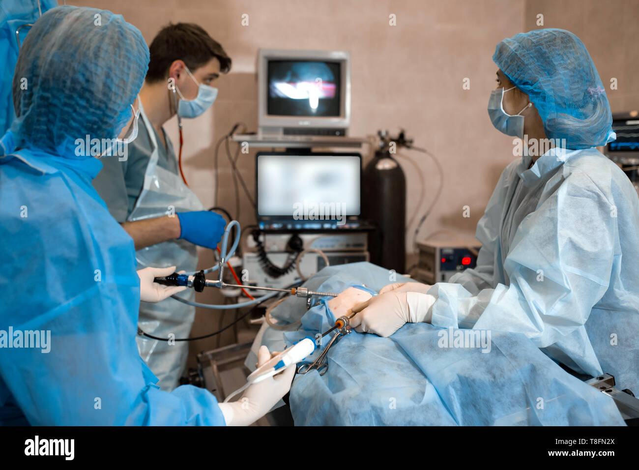 veterinarian or doctors doing surgery in the clinic. medicine, pet ...