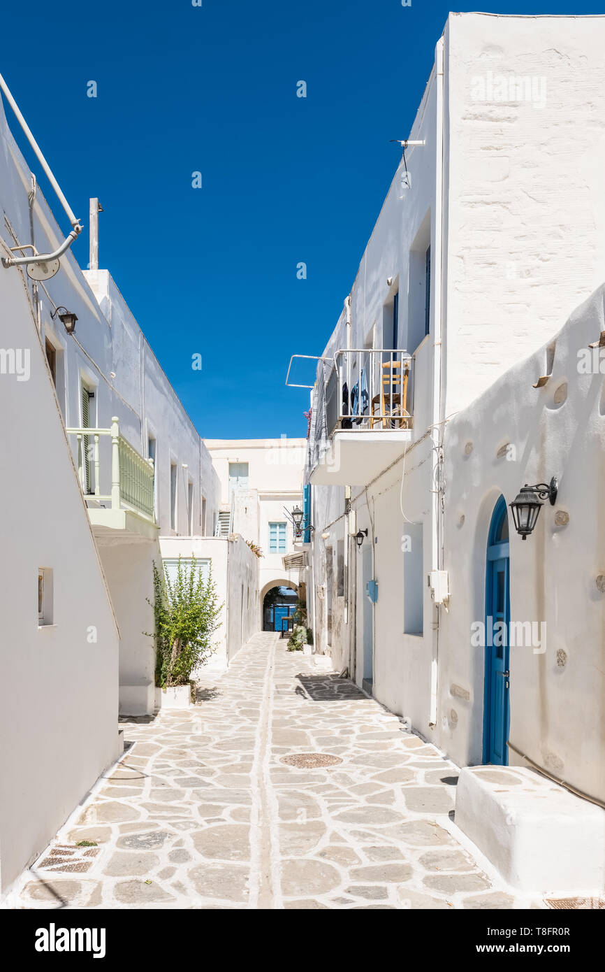 View of a typical narrow street in old town of Naoussa, Paros island ...