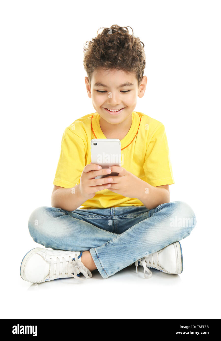 Cute little boy with mobile phone on white background Stock Photo - Alamy
