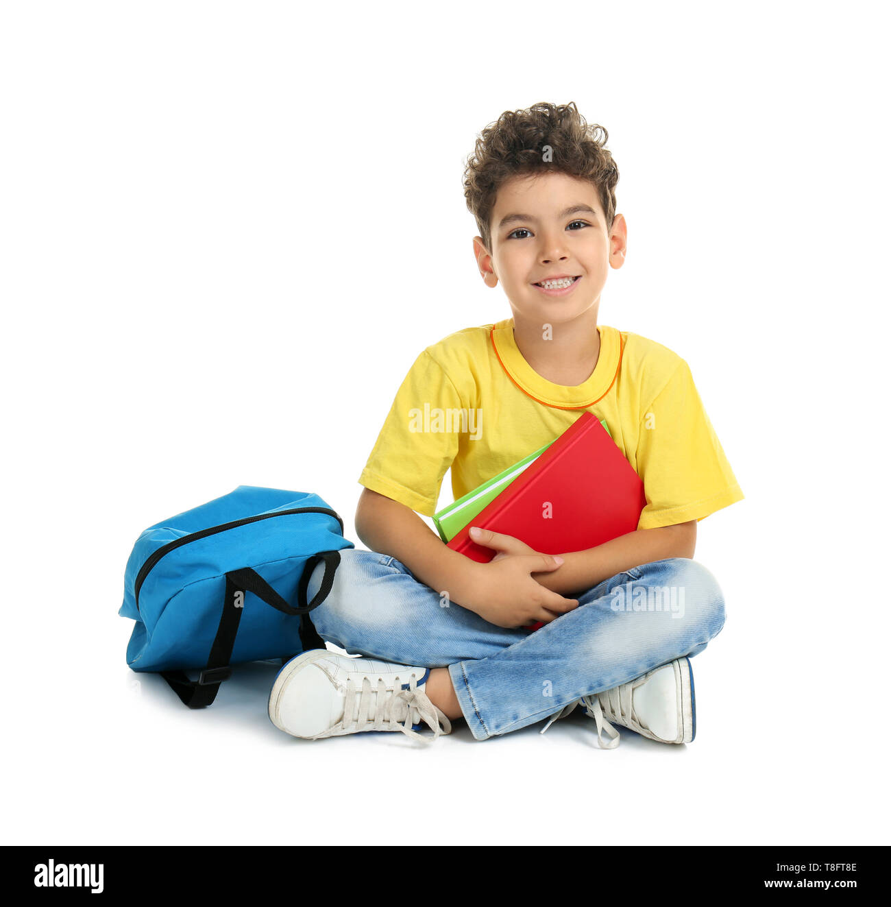Cute little boy with books on white background Stock Photo - Alamy