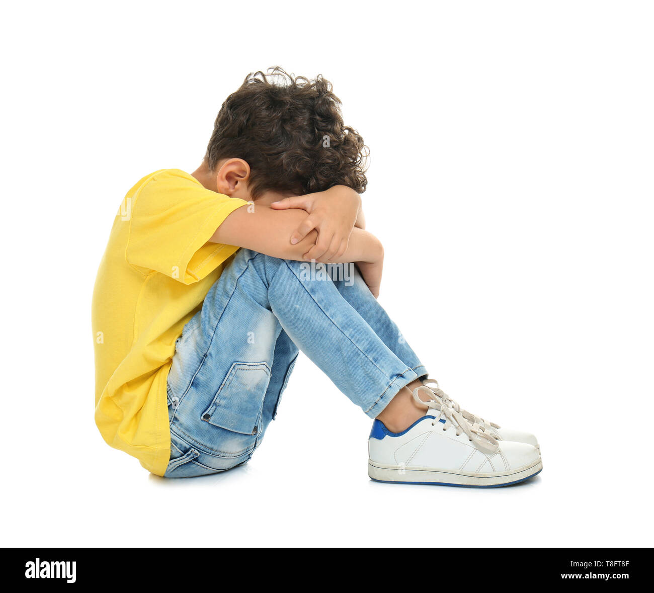 Upset little boy on white background Stock Photo - Alamy
