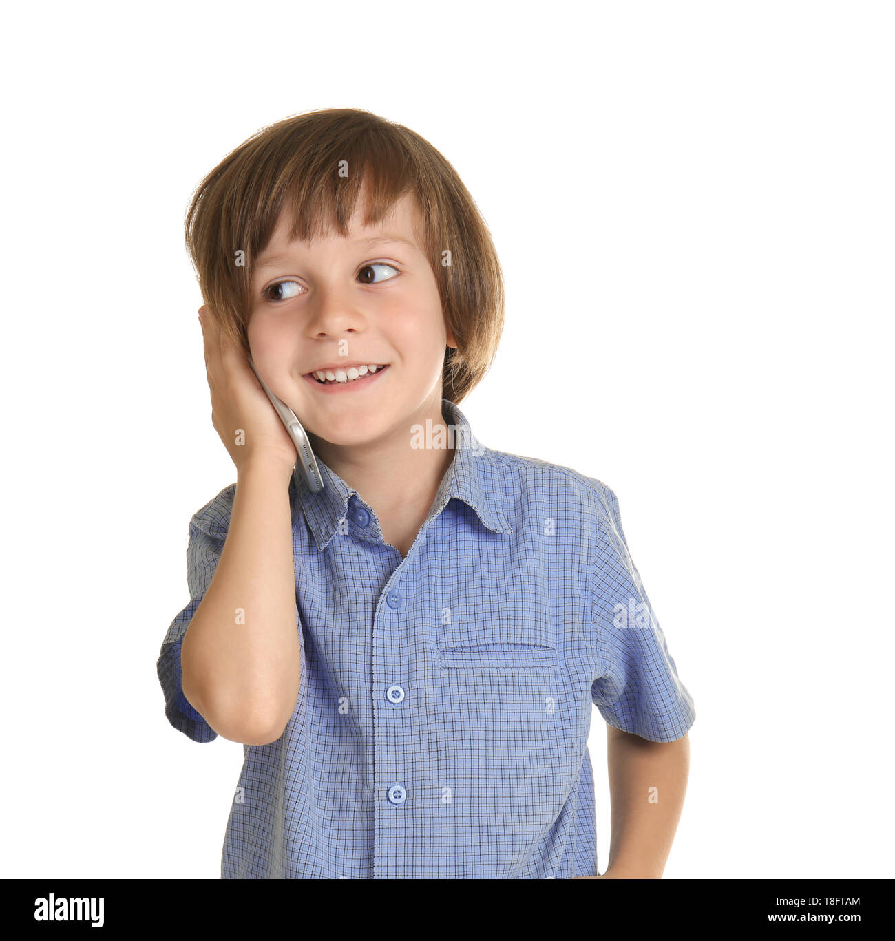Cute little boy talking on mobile phone against white background Stock ...