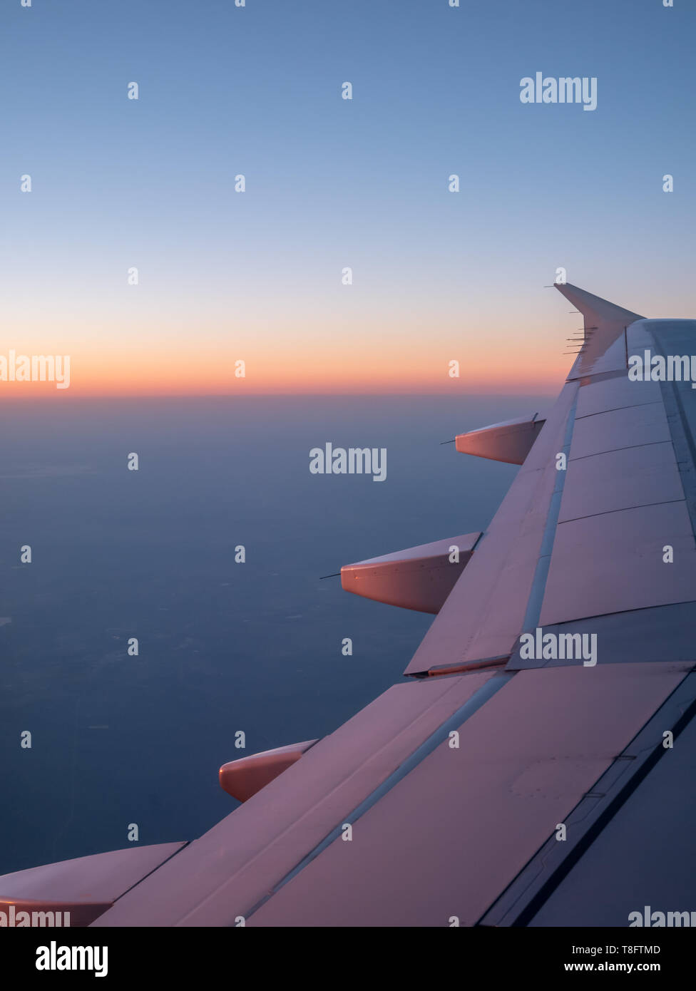 Side View of the Right Wing of an Airplane With Orange Tones from ...