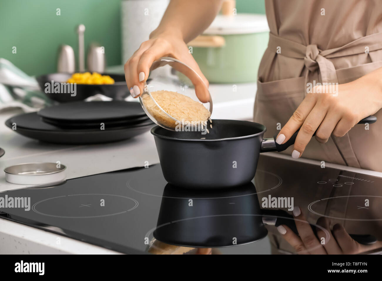 Woman pouring rice hi-res stock photography and images - Alamy