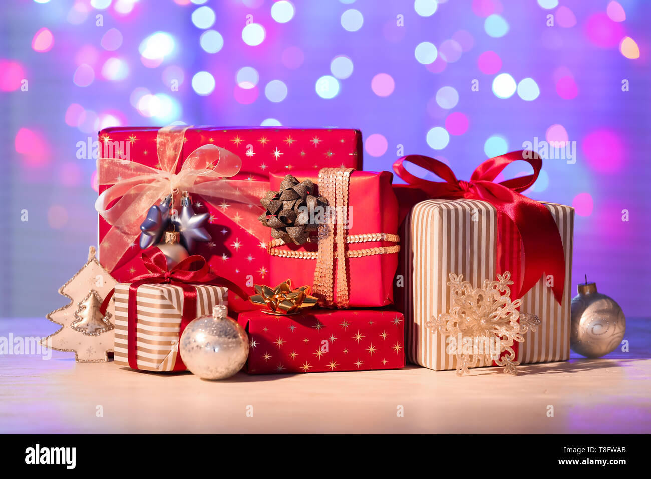 Beautiful Christmas gift boxes with decorations on table against ...