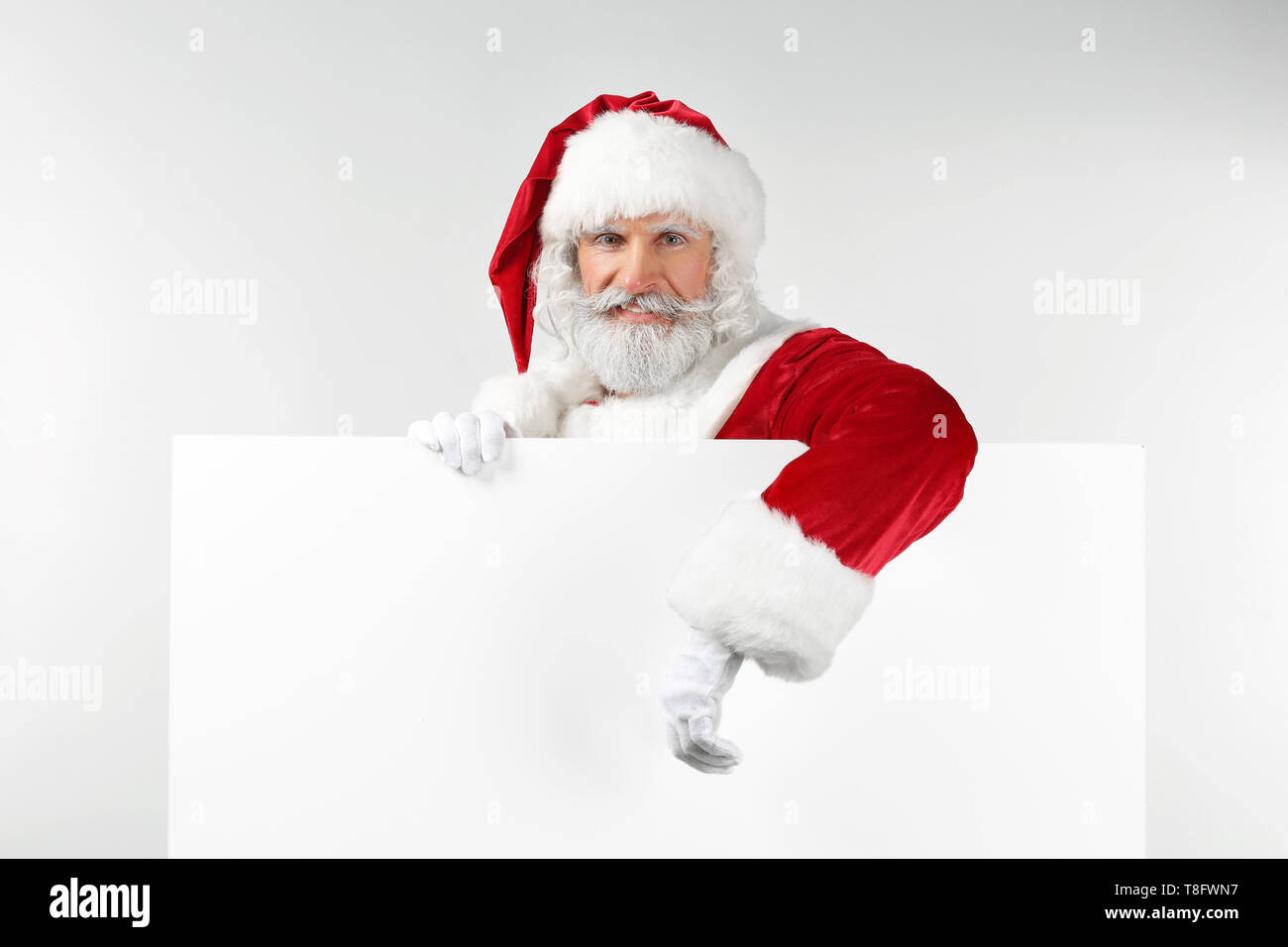 Portrait of Santa Claus with blank poster on white background Stock ...